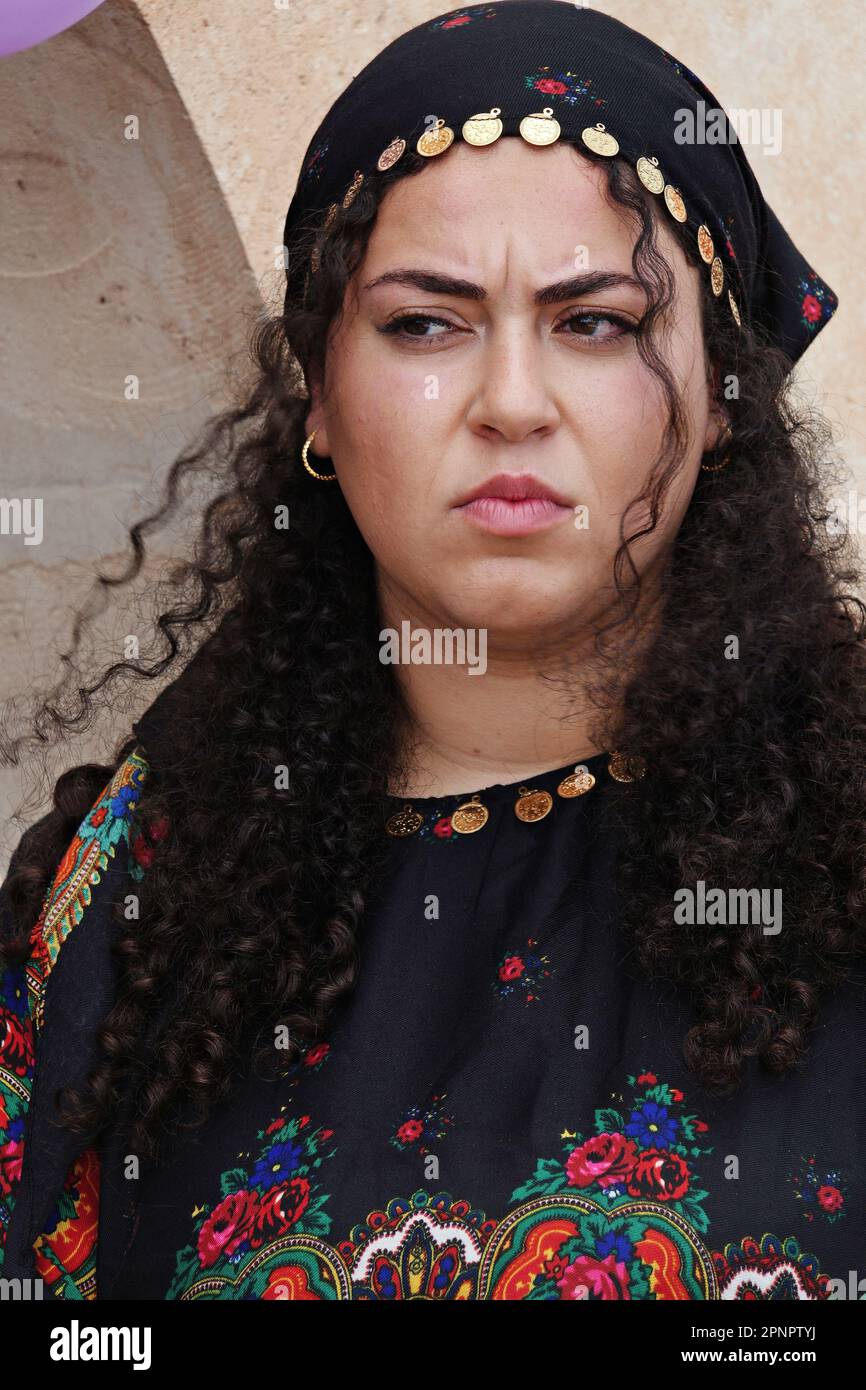 A Yazidi woman wearing colorful clothes participates in the celebration ...