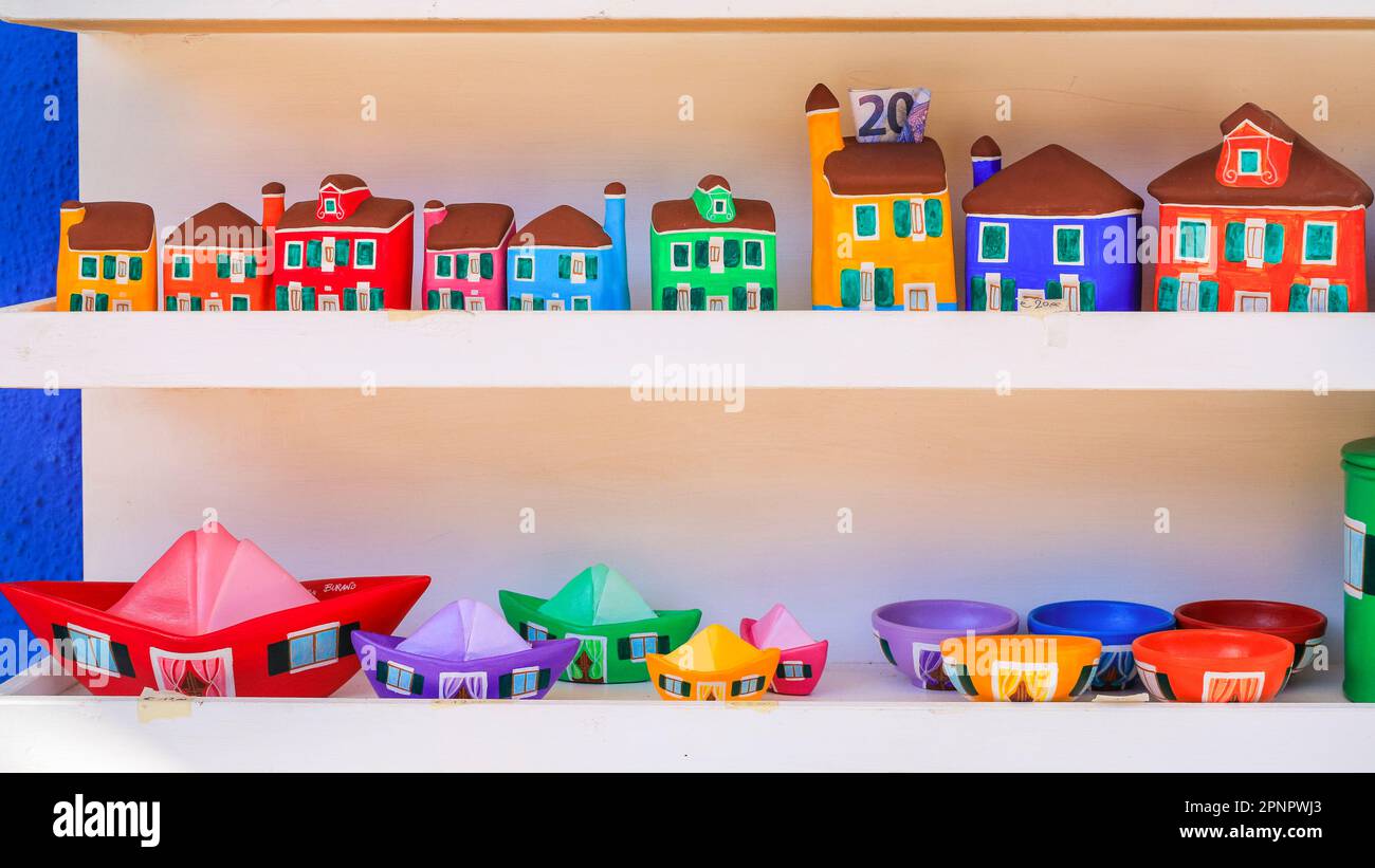 Burano Island souveniers, colourful terracotta houses and handicraft gifts on display, Venice ...