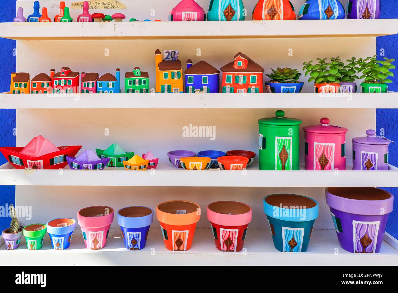 Burano Island souveniers, colourful terracotta houses and handicraft gifts on display, Venice ...