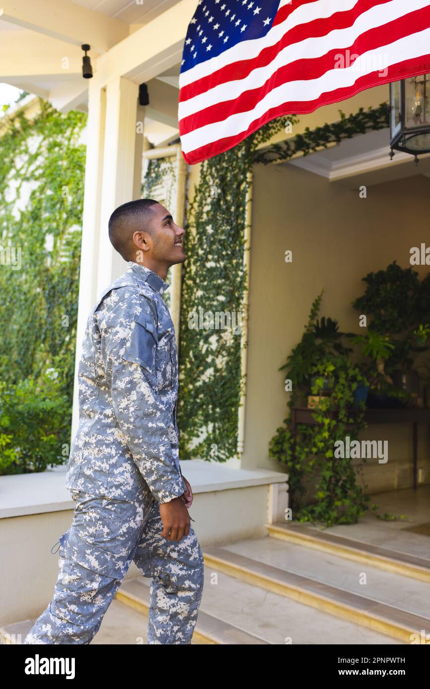 Happy biracial male american soldier wearing military uniform standing ...