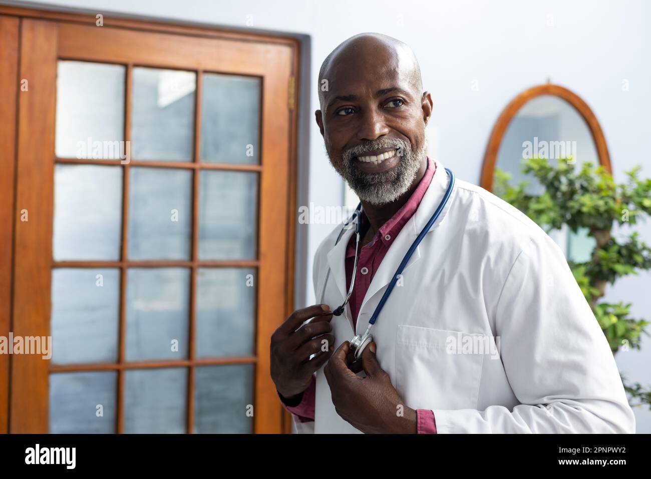 Happy african american male doctor wearing stethoscope and smiling at ...