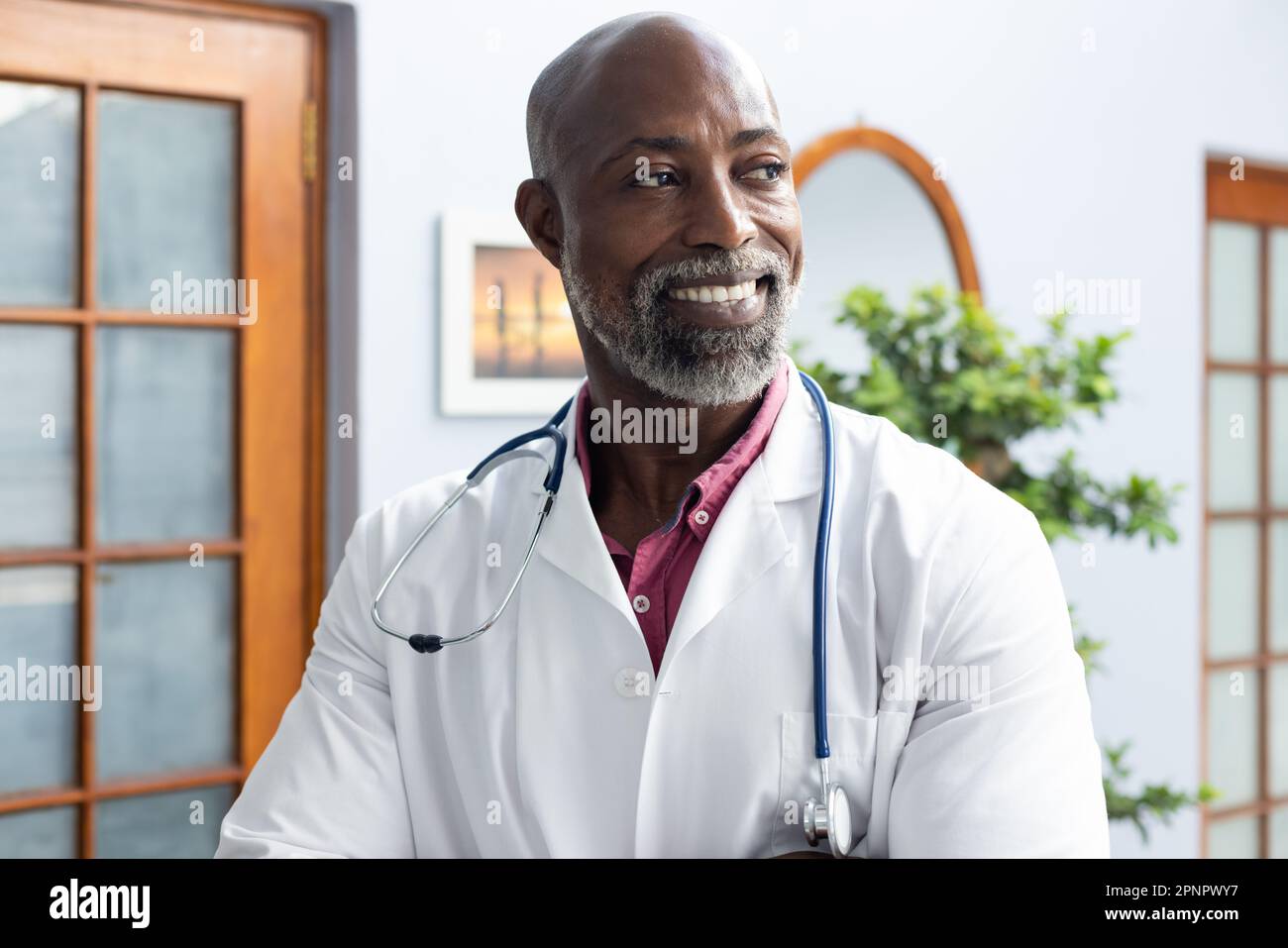 Happy african american male doctor wearing stethoscope and smiling at ...