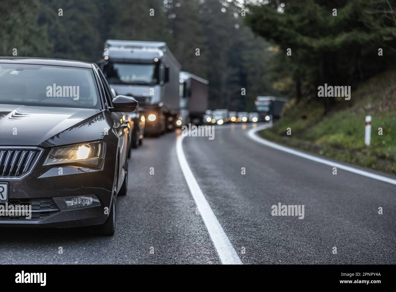 Traffic jam on a mountain road after several vehicles collided in front ...
