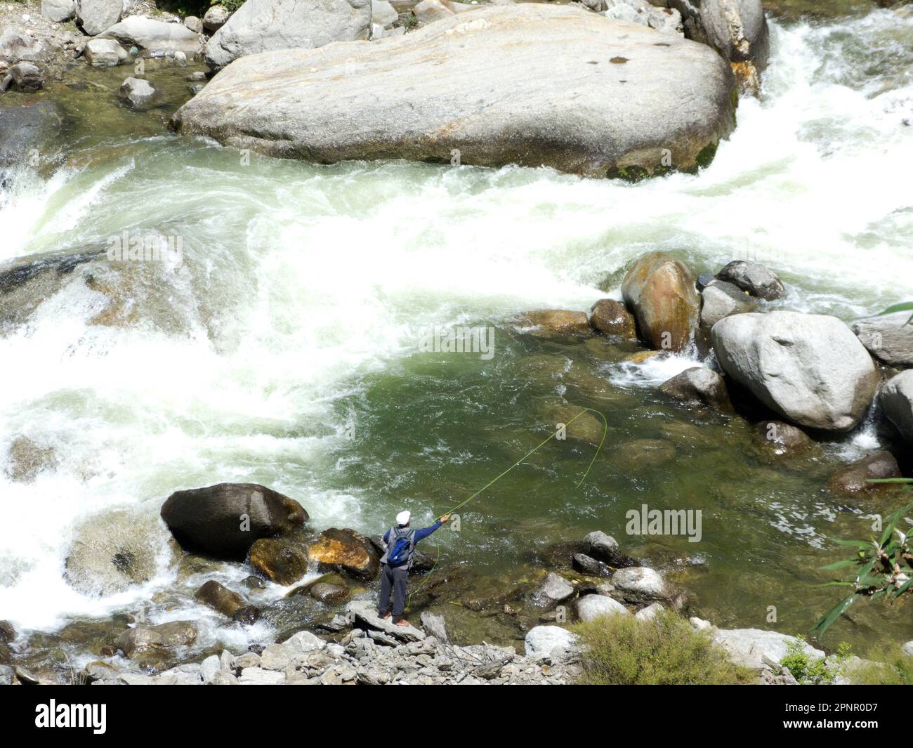 Aerial view of a man Trout fishing in Tirthan River, Himachal Pradesh ...