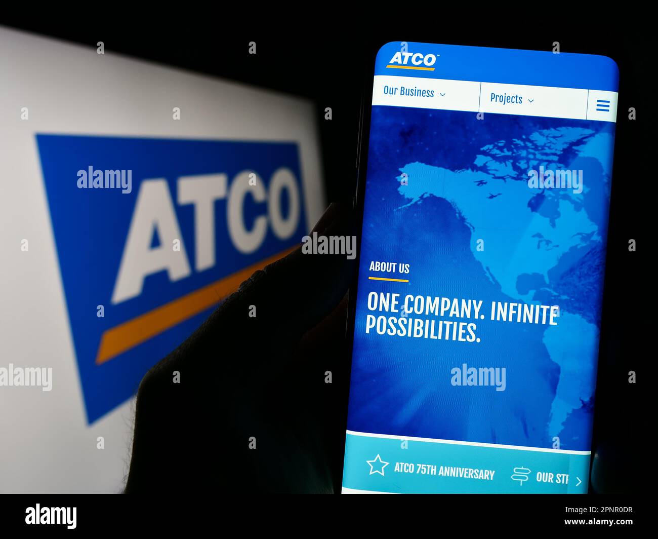 Person holding mobile phone with website of Canadian energy company ...