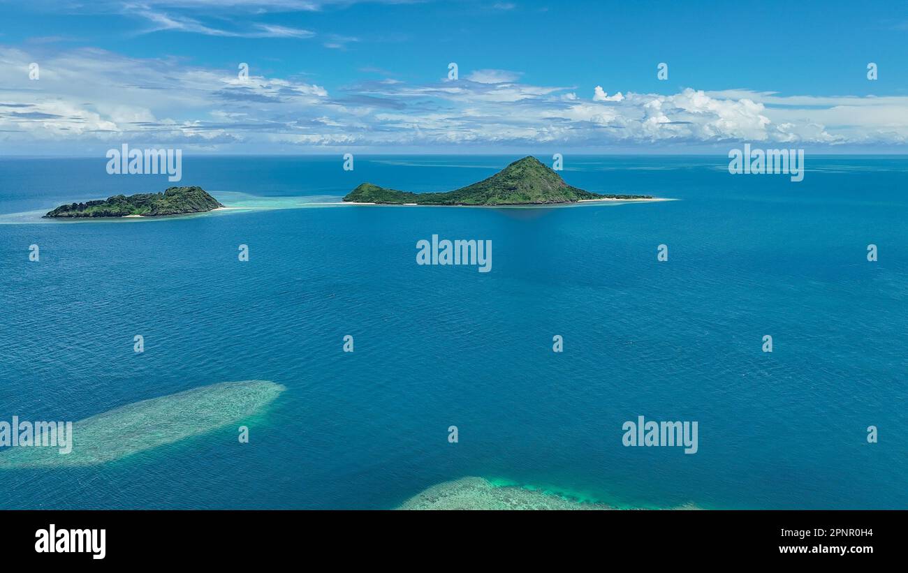Aerial view of tropical island with clear blue water in Torres Strait ...