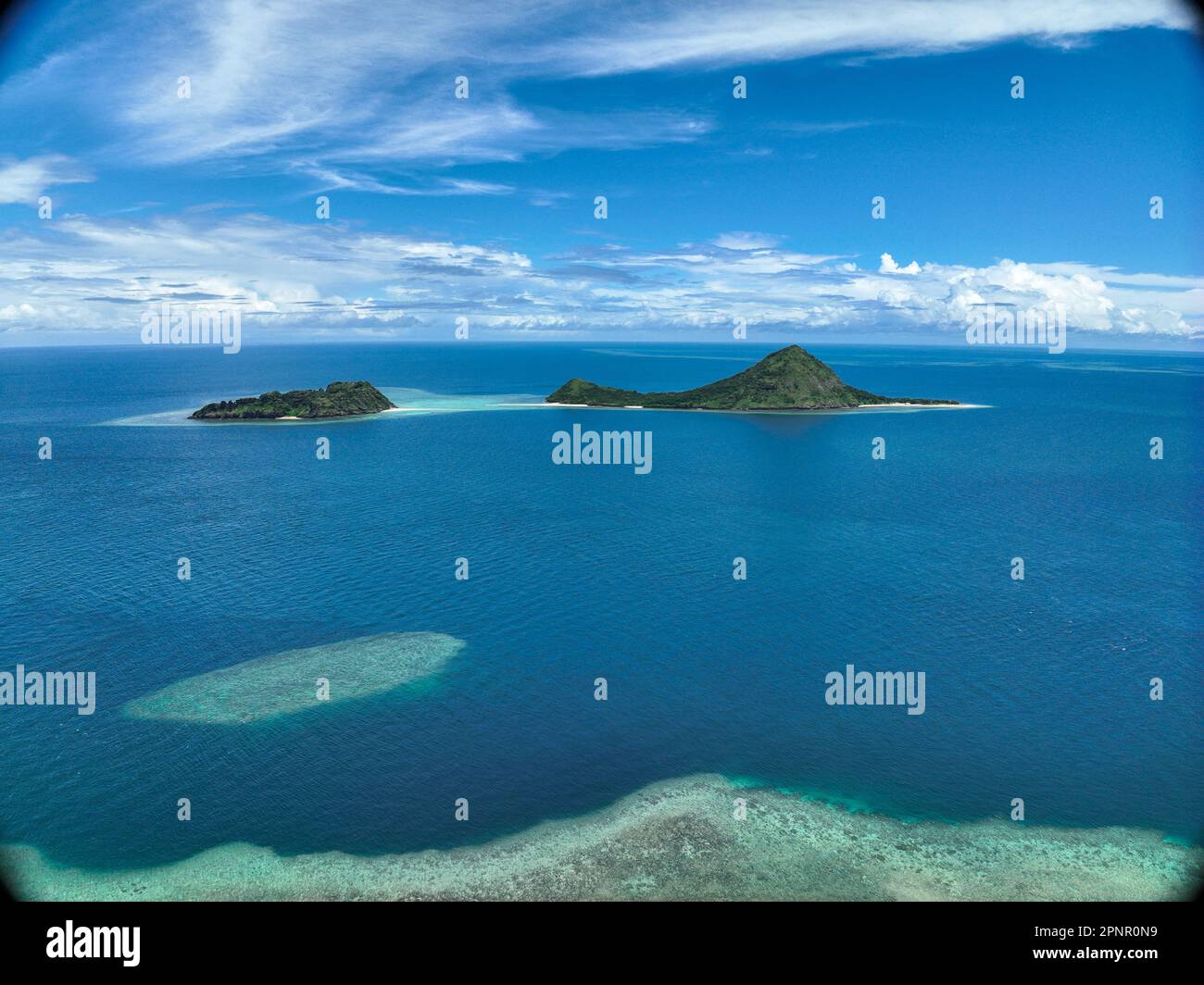 Aerial view of tropical island with clear blue water in Torres Strait ...