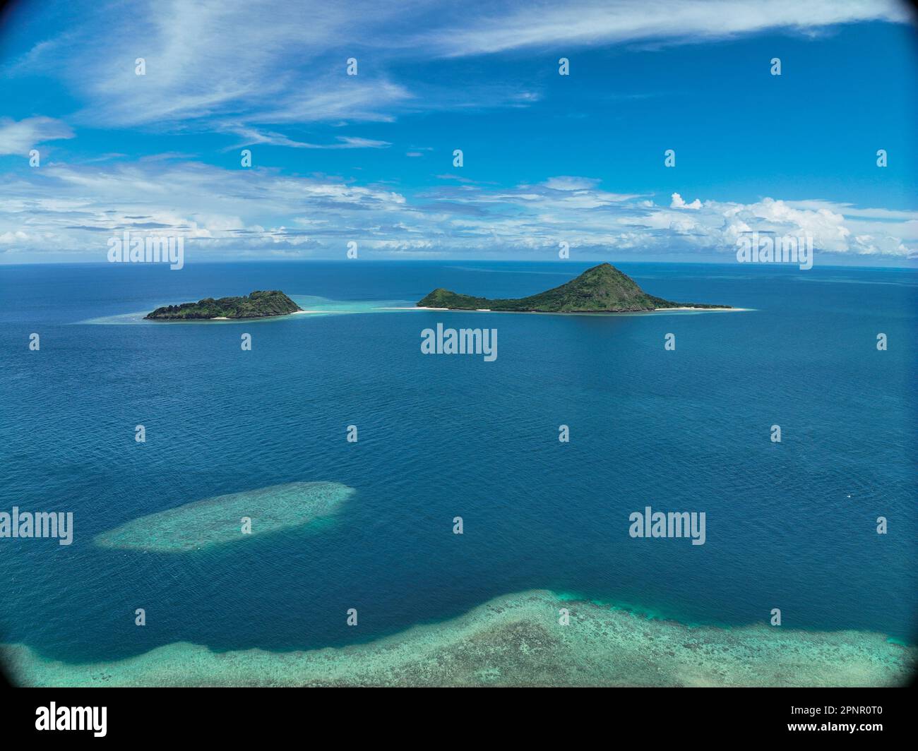 Aerial view of tropical island with clear blue water in Torres Strait ...