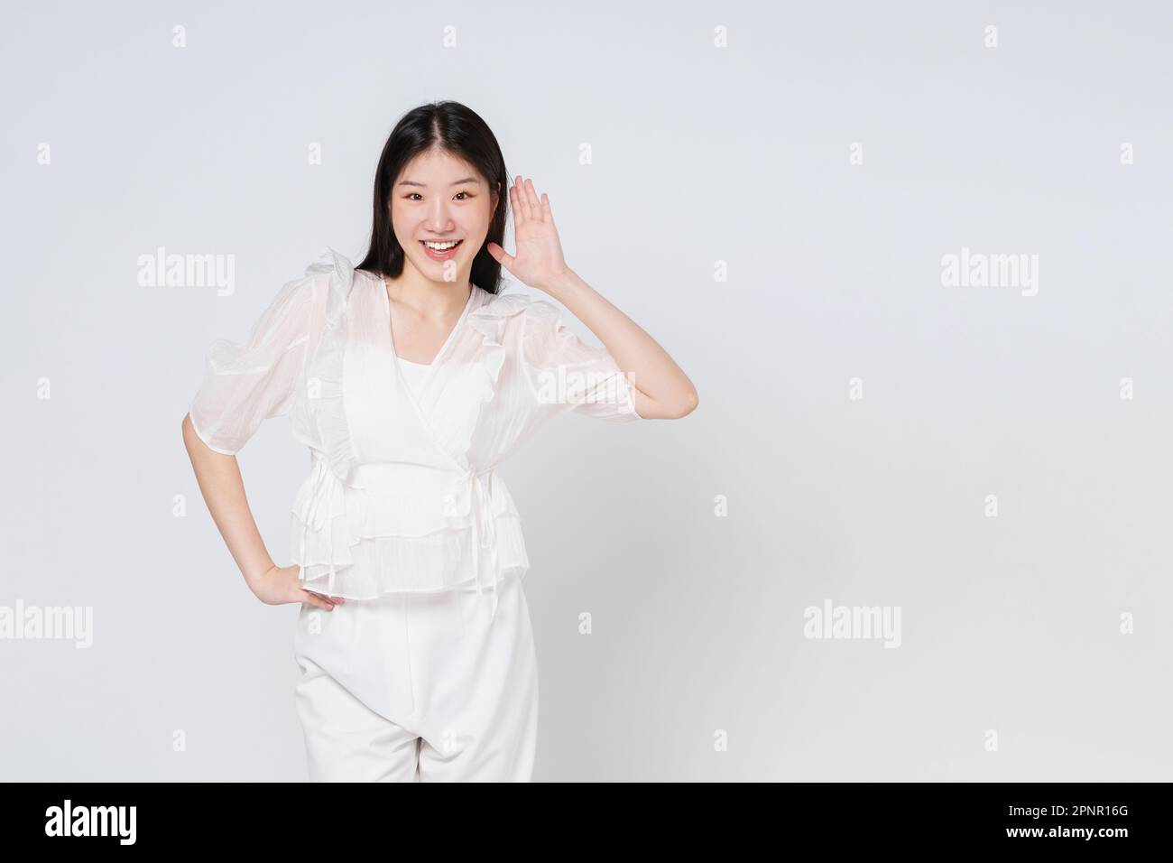 Happy young woman try to hearing you overhear listening sound to gossip ...