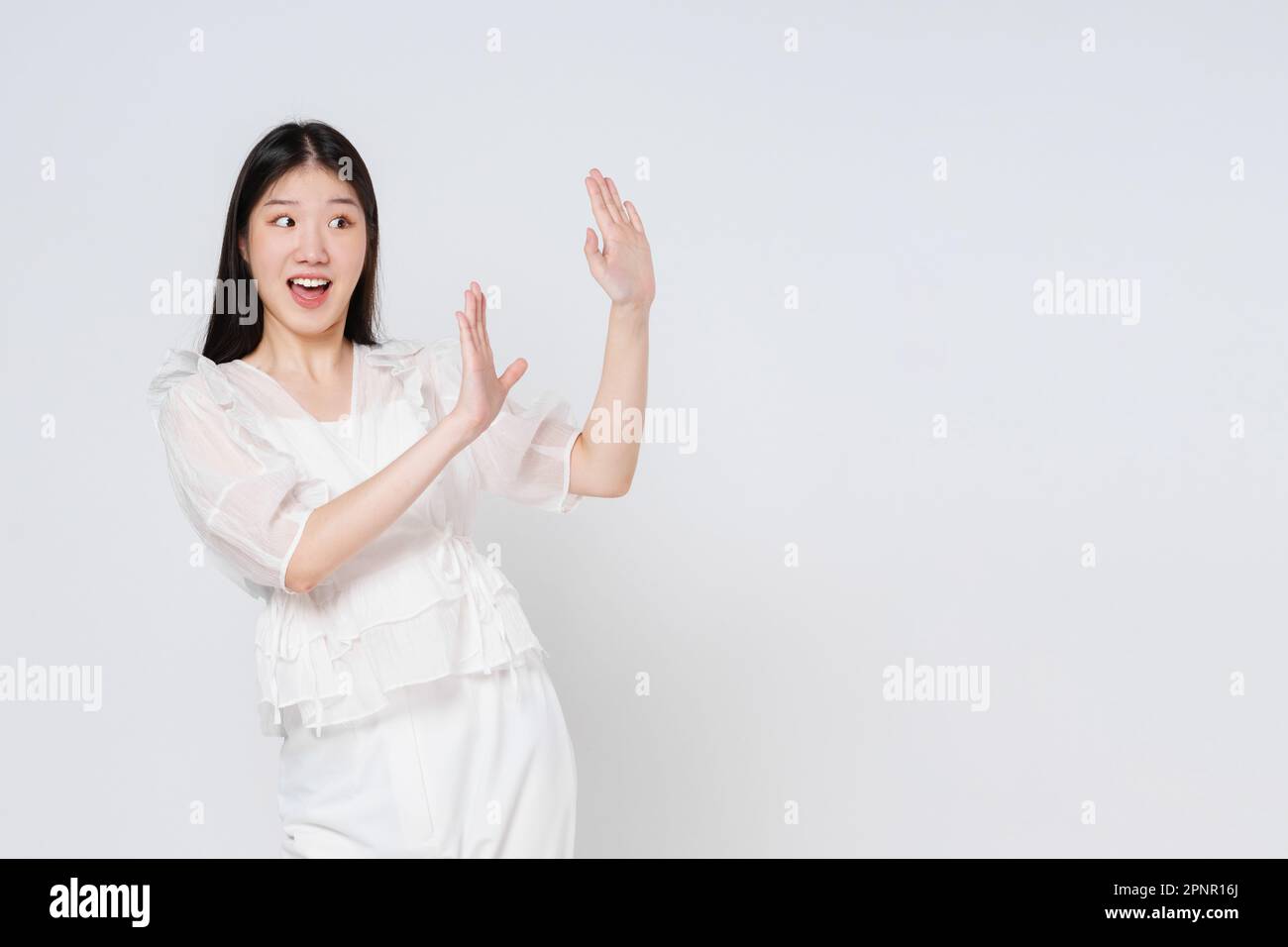 Young woman act like a pushing something isolated on white background ...