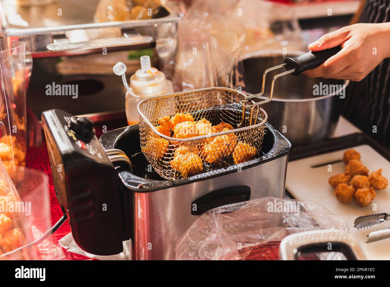 Female chef deep fried meat ball in kitchen Stock Photo - Alamy