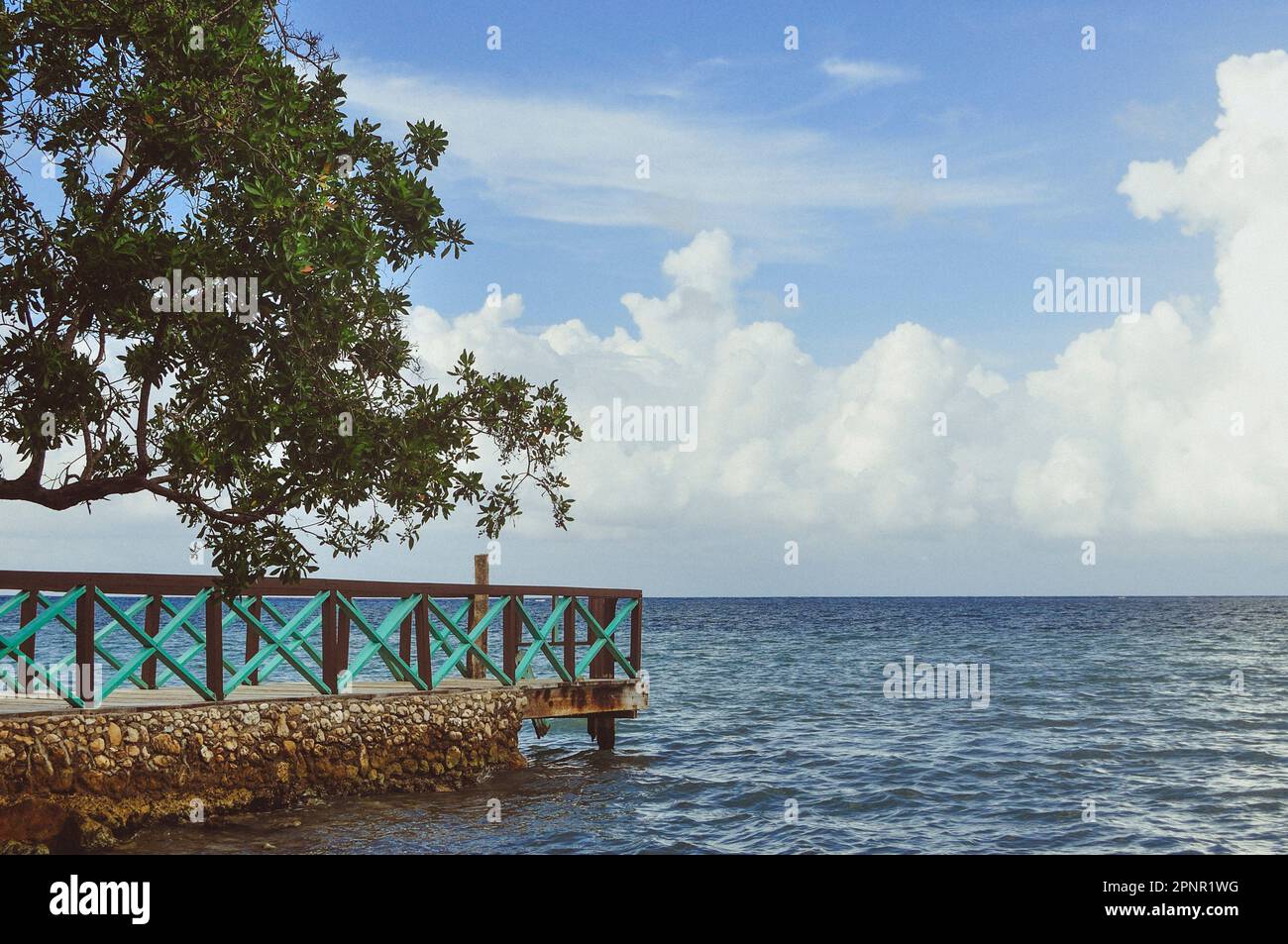 Wooden pier on a tropical beach, Jamaica Stock Photo - Alamy