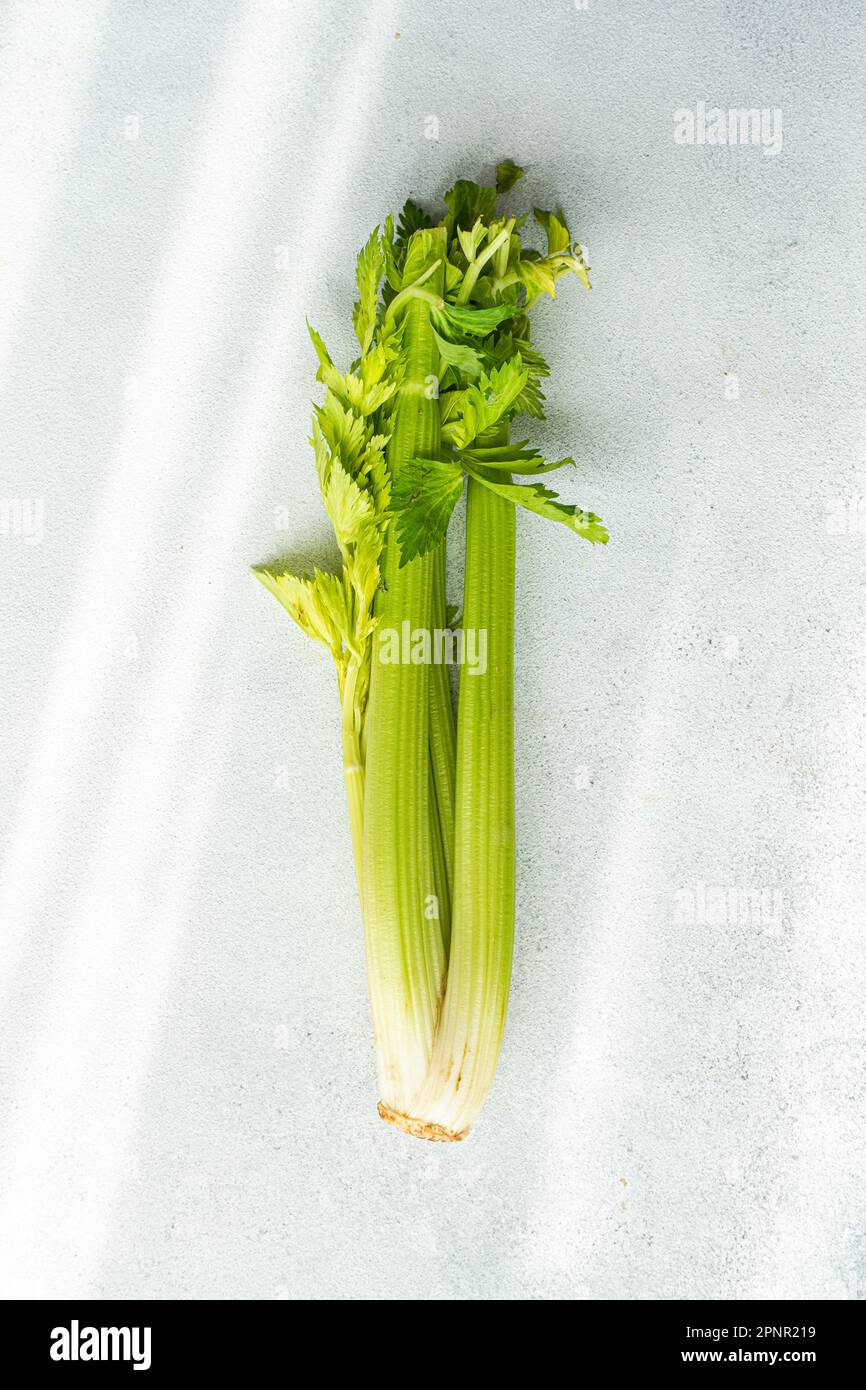 Overhead view of a bunch of fresh celery on a table Stock Photo - Alamy