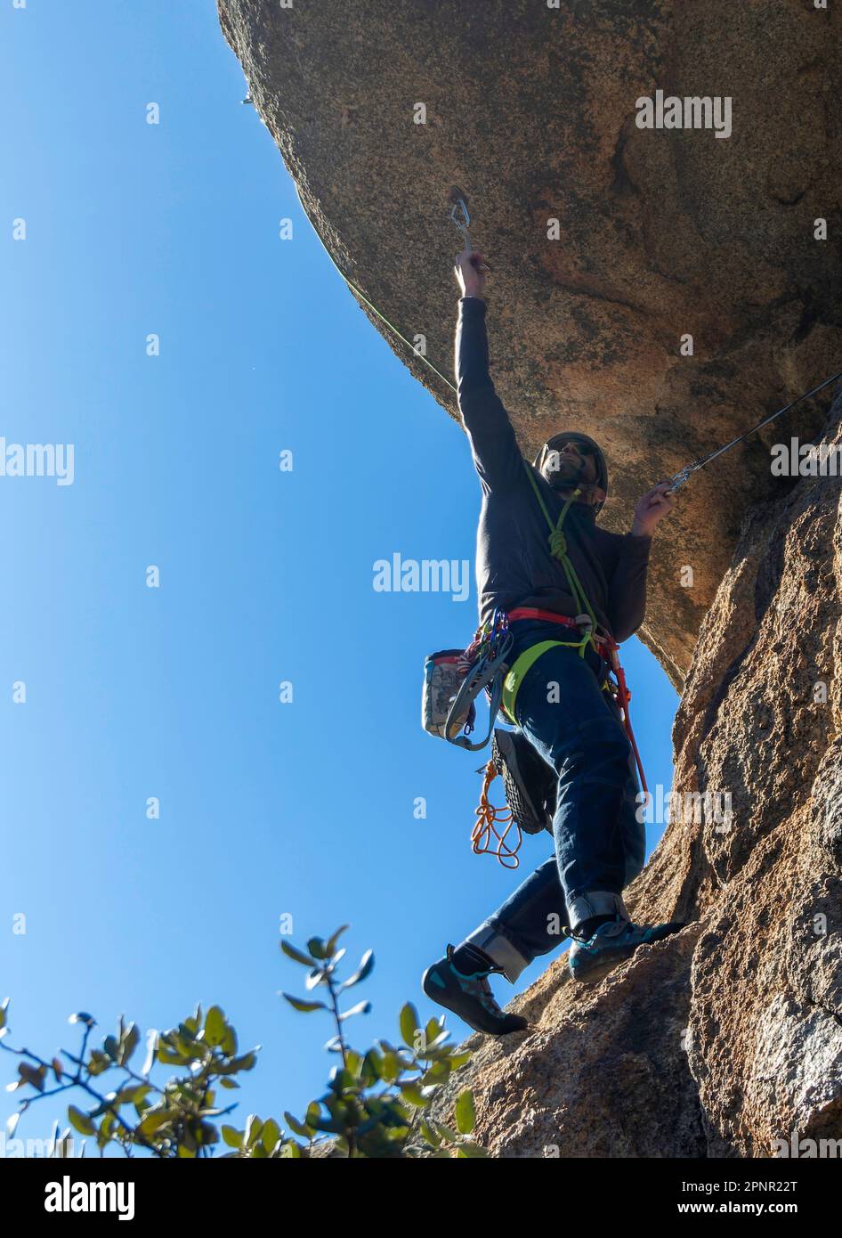 Young adult climbing a granite overhang at Torrelodones, Madrid. Rock ...