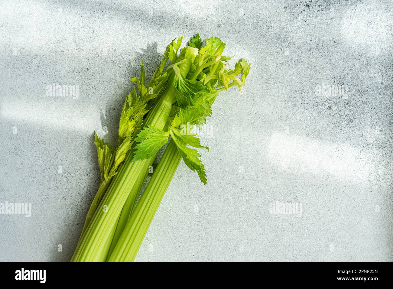 Overhead view of a bunch of fresh celery on a table Stock Photo - Alamy