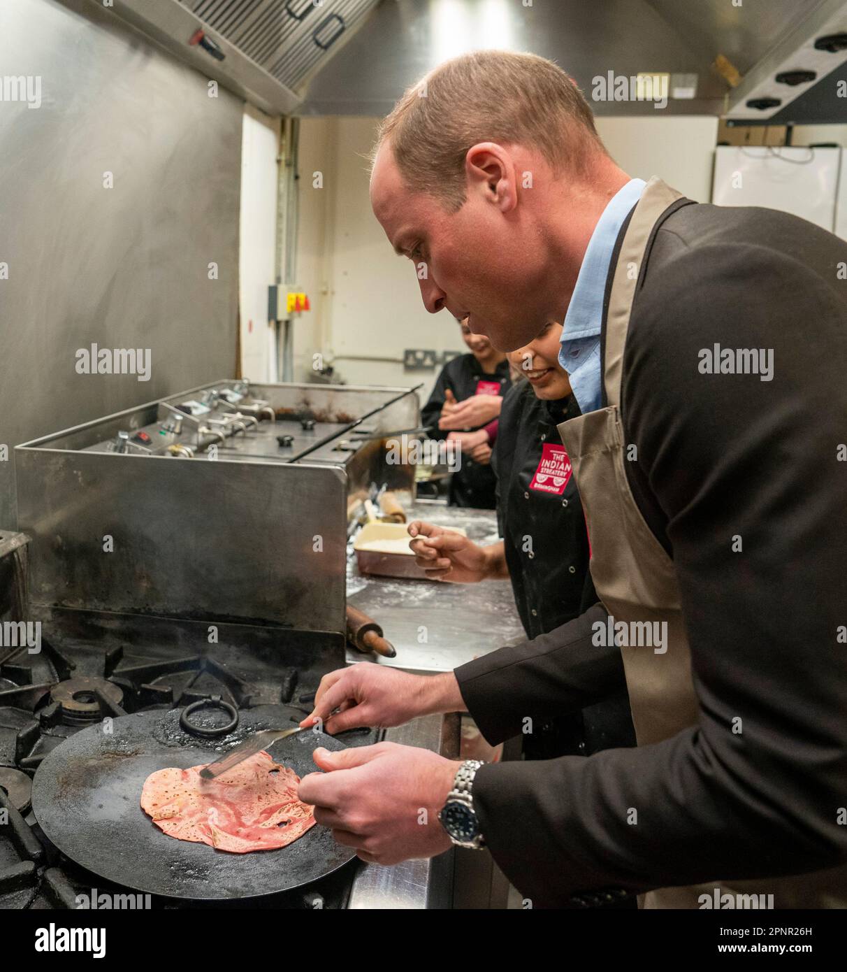 Britain's Prince William cooks, during a visit to The Indian Streatery ...