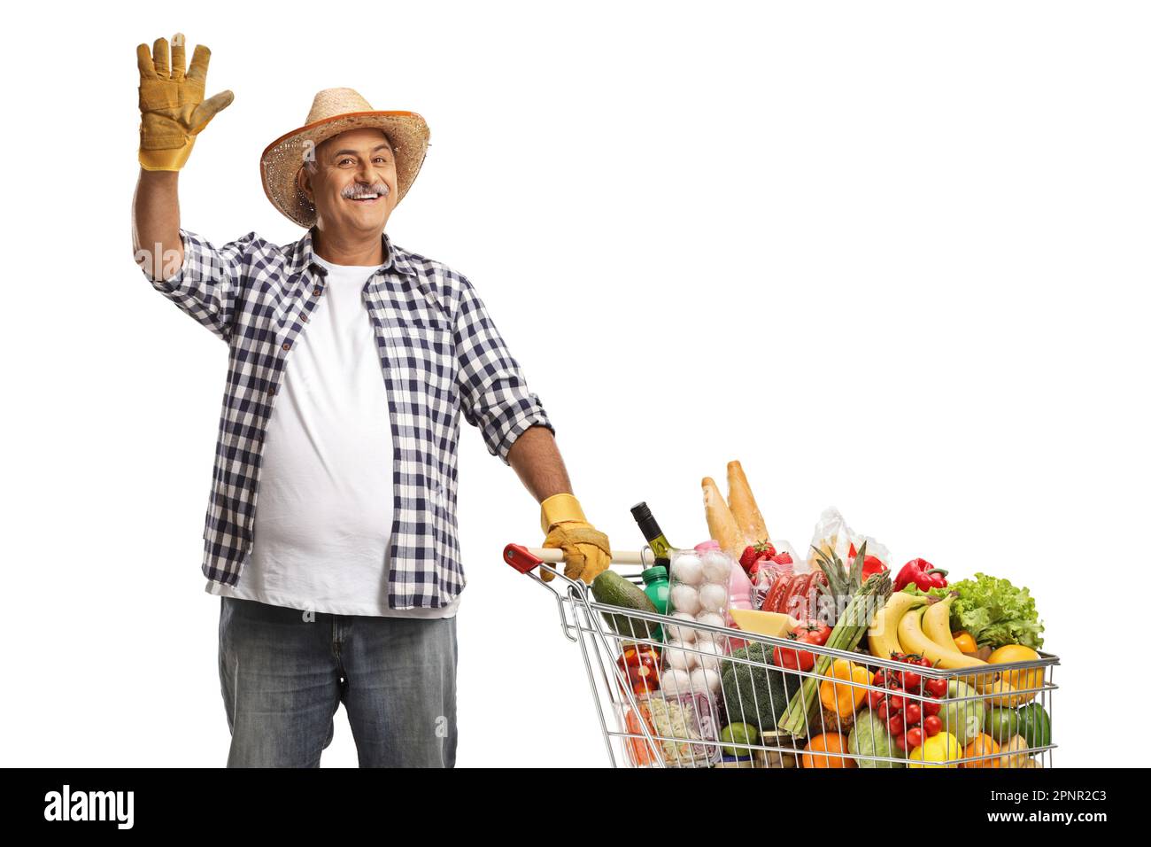 Farmer with a shopping cart full of food products waving at camera ...