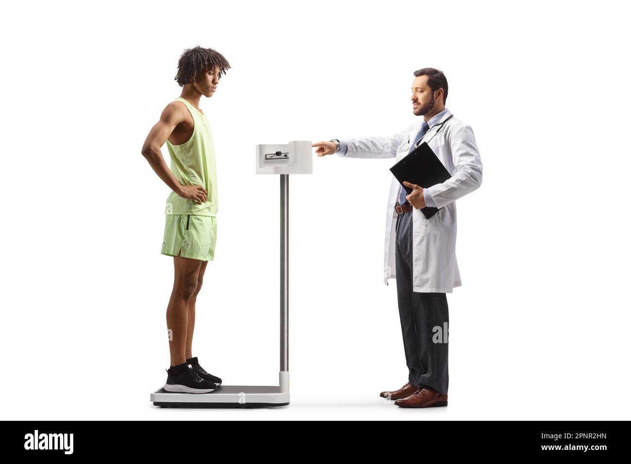 Doctor measuring a young african american male patient in sportswear on ...