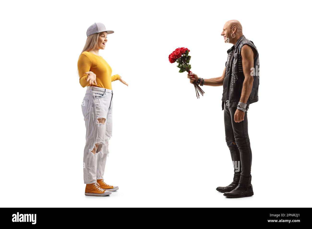 Full length profile shot of a punk giving a bouquet of red roses to a ...