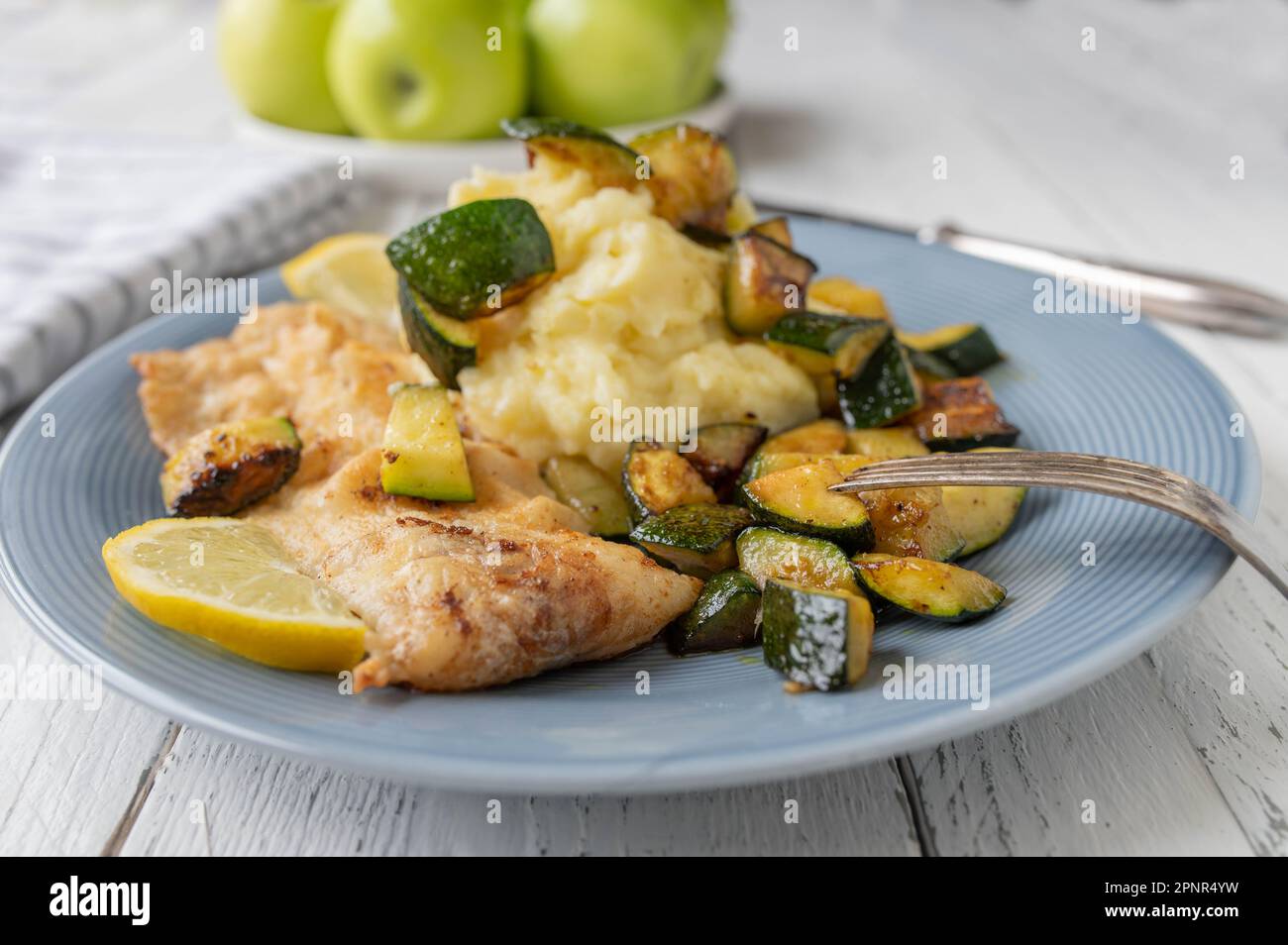 Pan fried fish fillet with mashed potatoes and roasted zucchini on a ...