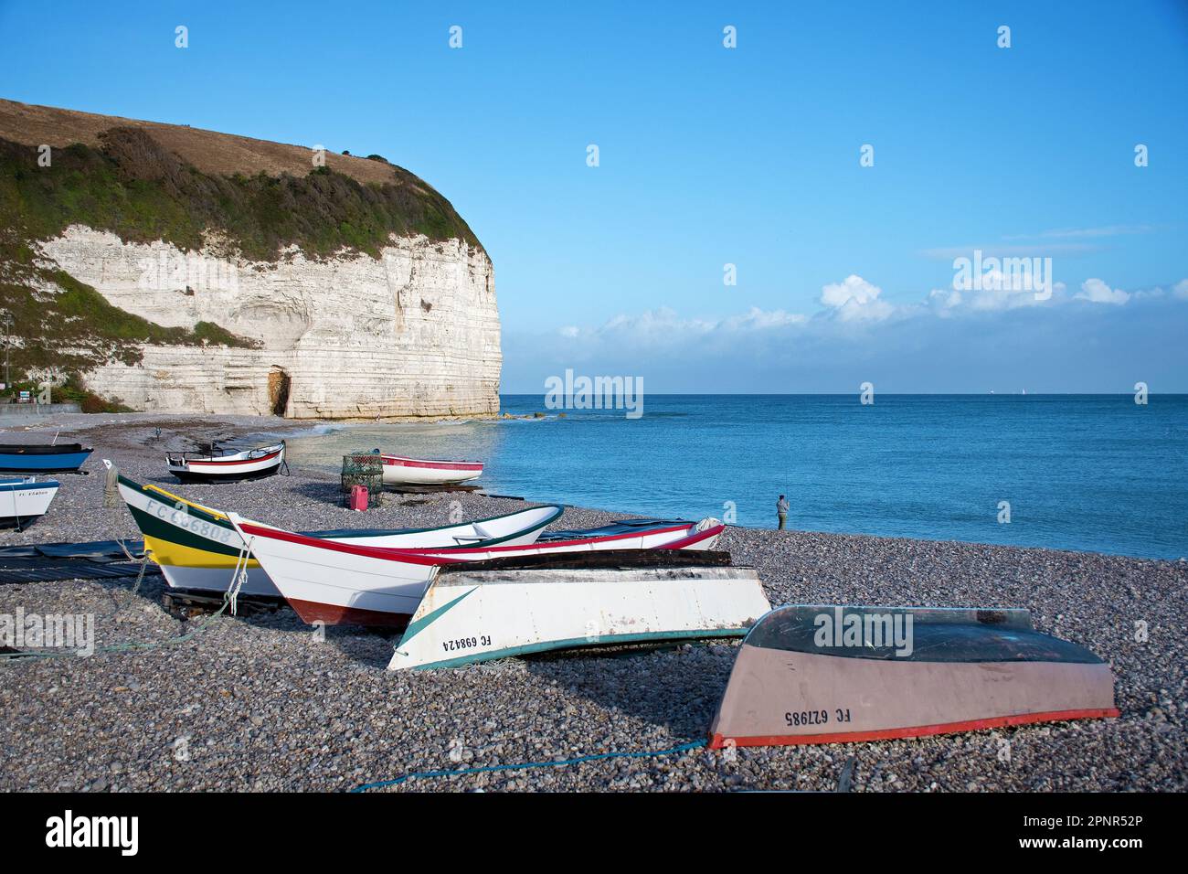 Yport beach with colourful fishing boats and the Falaise d'Aval in the ...