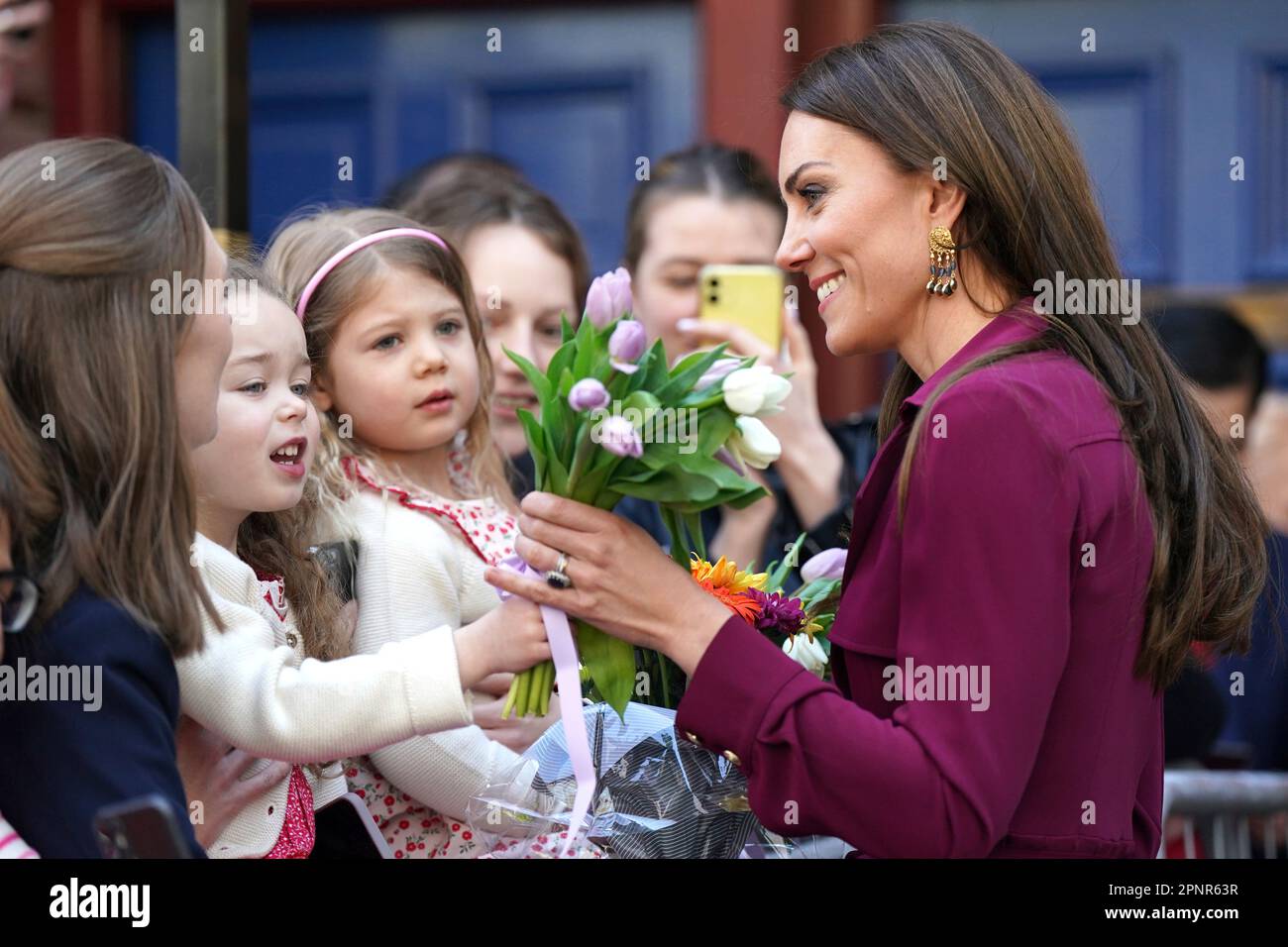 Britain's Kate, Princess of Wales, speaks with children during a visit ...