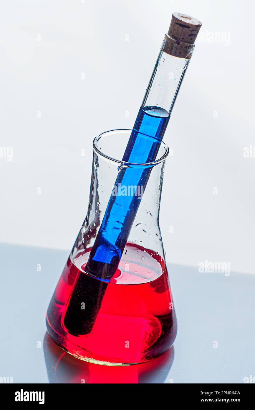 Medical tubes with liquid stand on mirror table. Chemical and ...