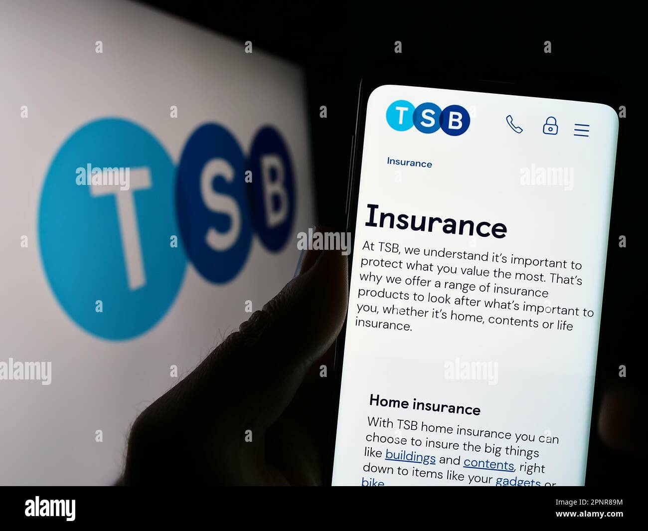 Person holding cellphone with webpage of British financial company TSB ...