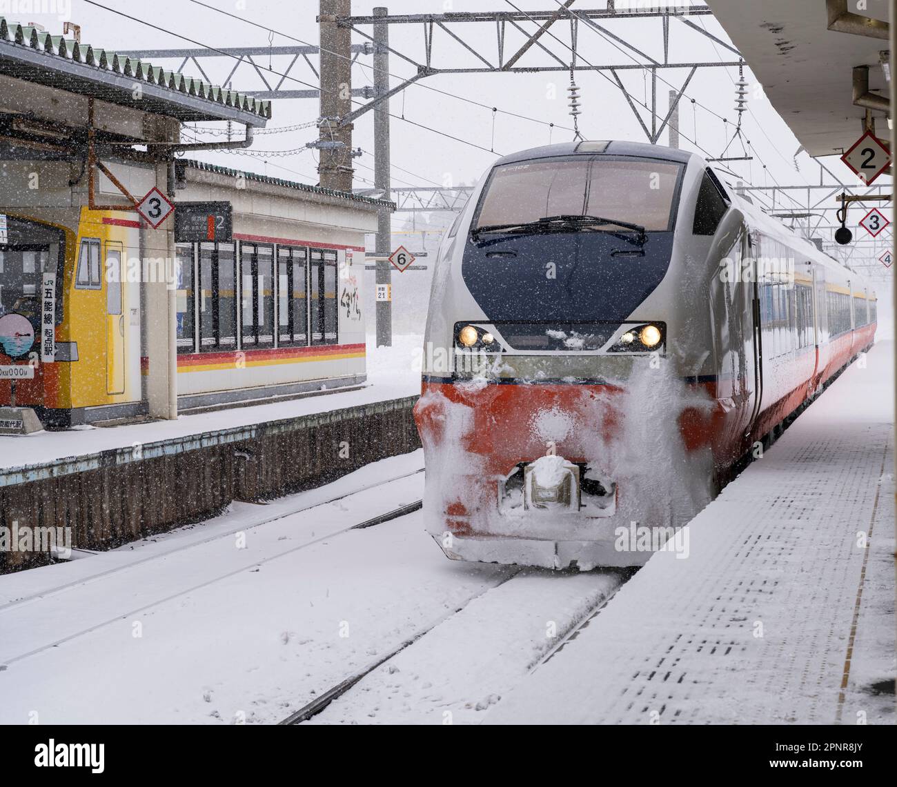 A JR East E751 Series Tsugaru express train arriving at Higashi-Noshiro Station in winter in ...