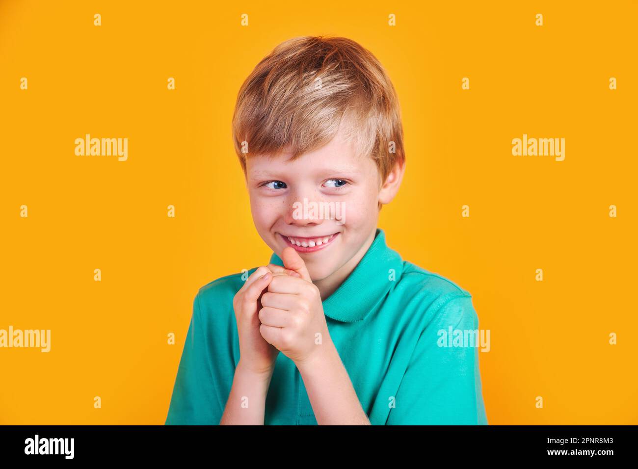 Closeup portrait of sneaky sly scheming kid boy on yellow background ...