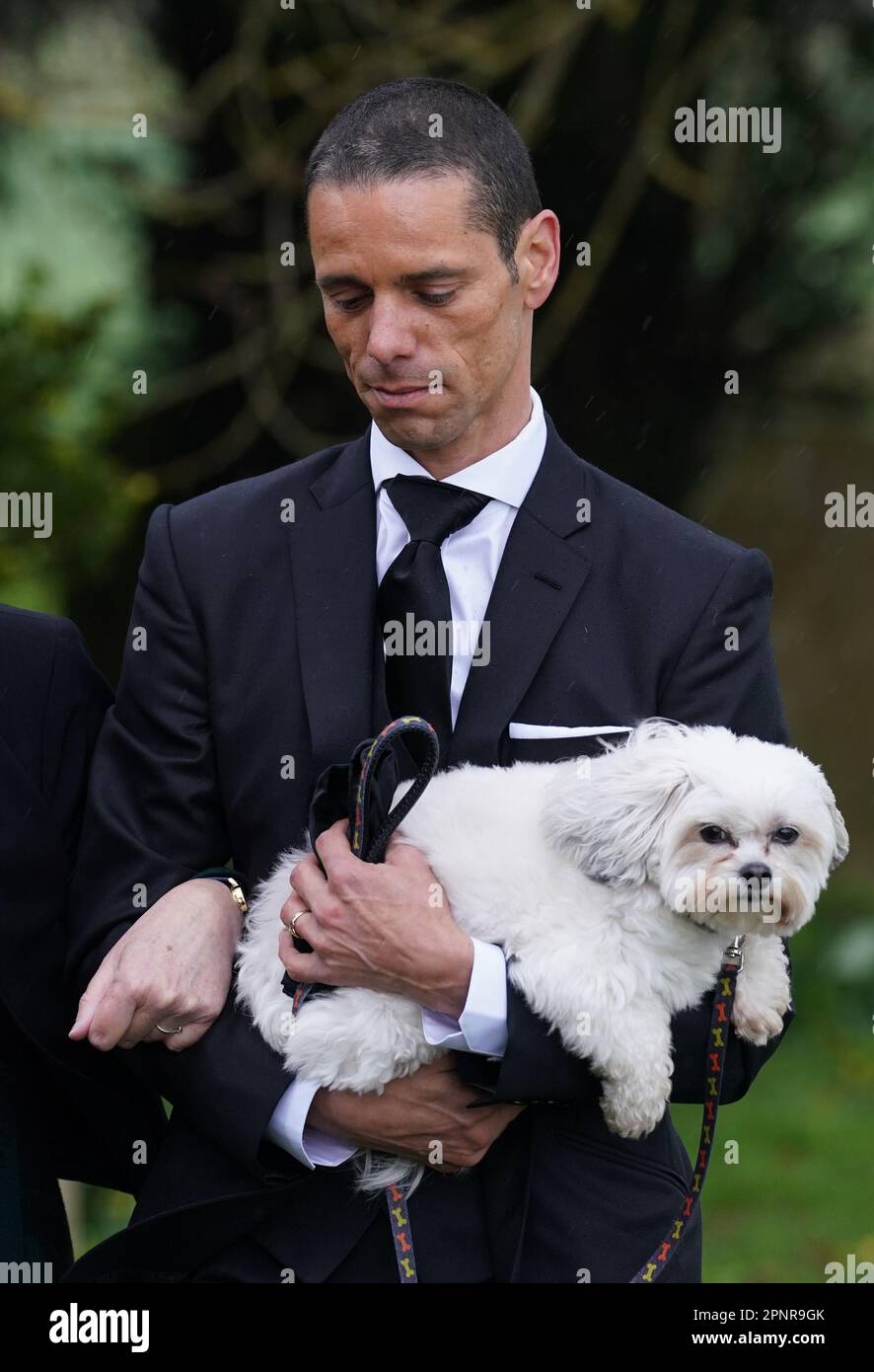 Husband of Paul O'Grady, Andre Portasio, carrying one of their dogs ...