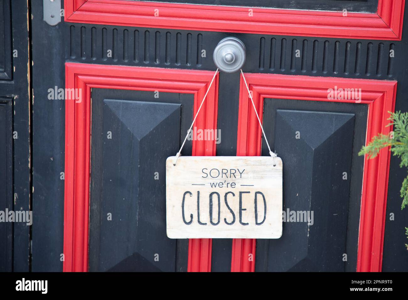 Sorry we are closed sign board wooden panel hanging on door of cafe ...