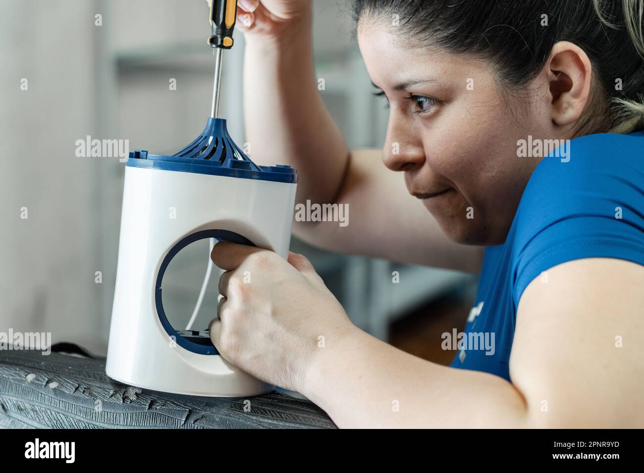 Woman disassembling appliance hi-res stock photography and images - Alamy