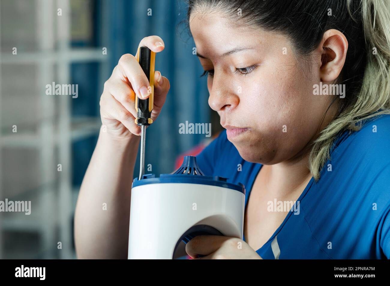 Woman disassembling appliance hi-res stock photography and images - Alamy