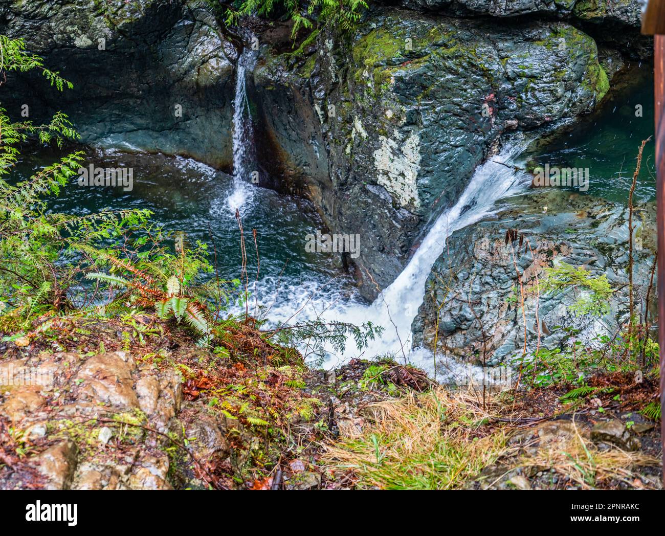 Water flows through a rock outlet below Twin Falls in Washington State ...