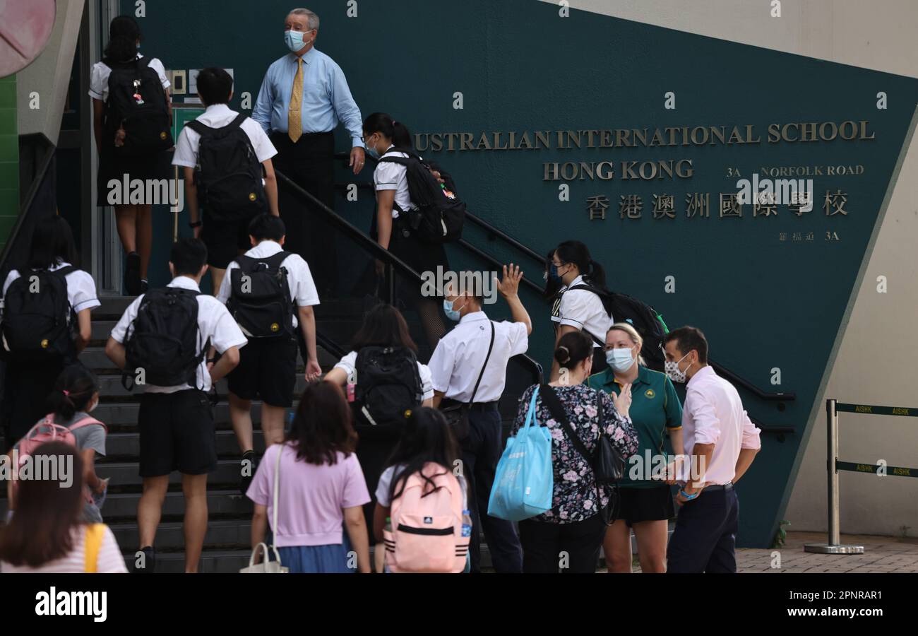 Students enter the campus at National flag raising at Australian International School, Kowloon ...