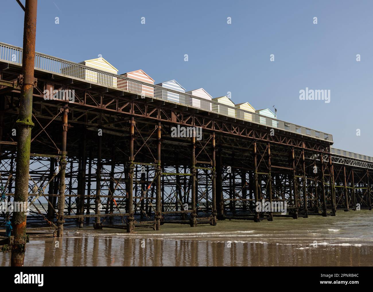 Hastings Pier and beach huts from below Stock Photo - Alamy