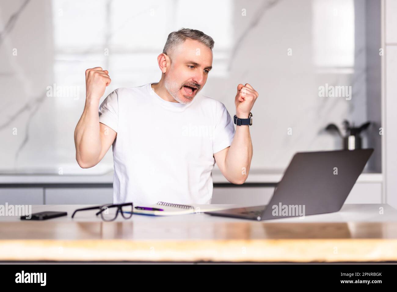 Happy excited old man winner excited by reading good news looking at ...