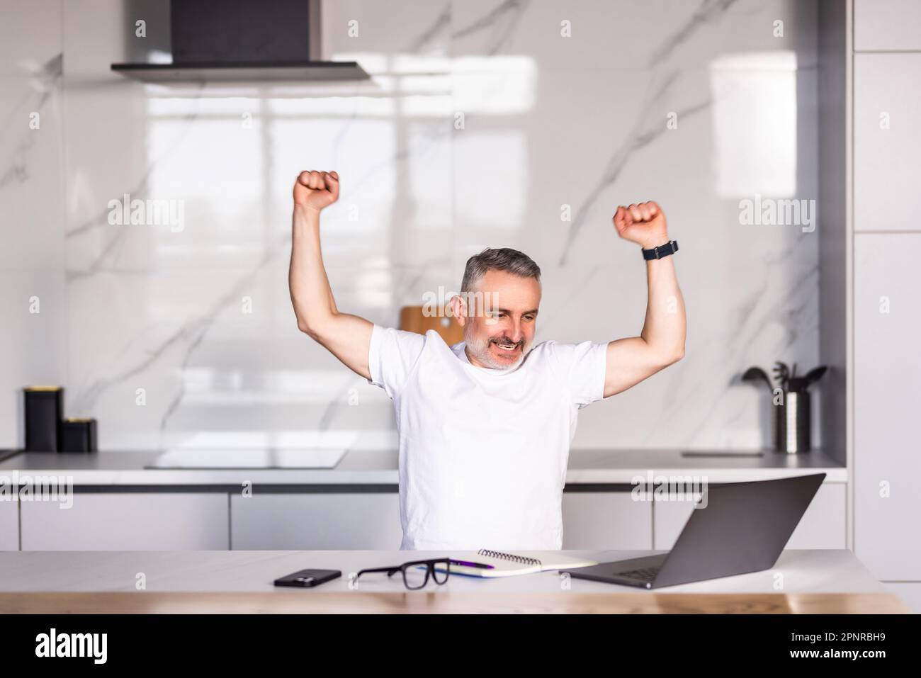 Happy excited old man winner excited by reading good news looking at ...