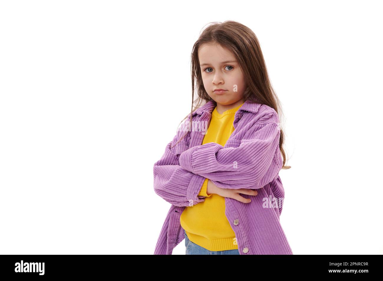 Naughty mischievous little girl pouting lips in resentment, looking at ...