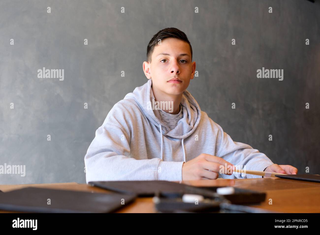 Young handsome man eating sushi sitting on the table thinking looking ...