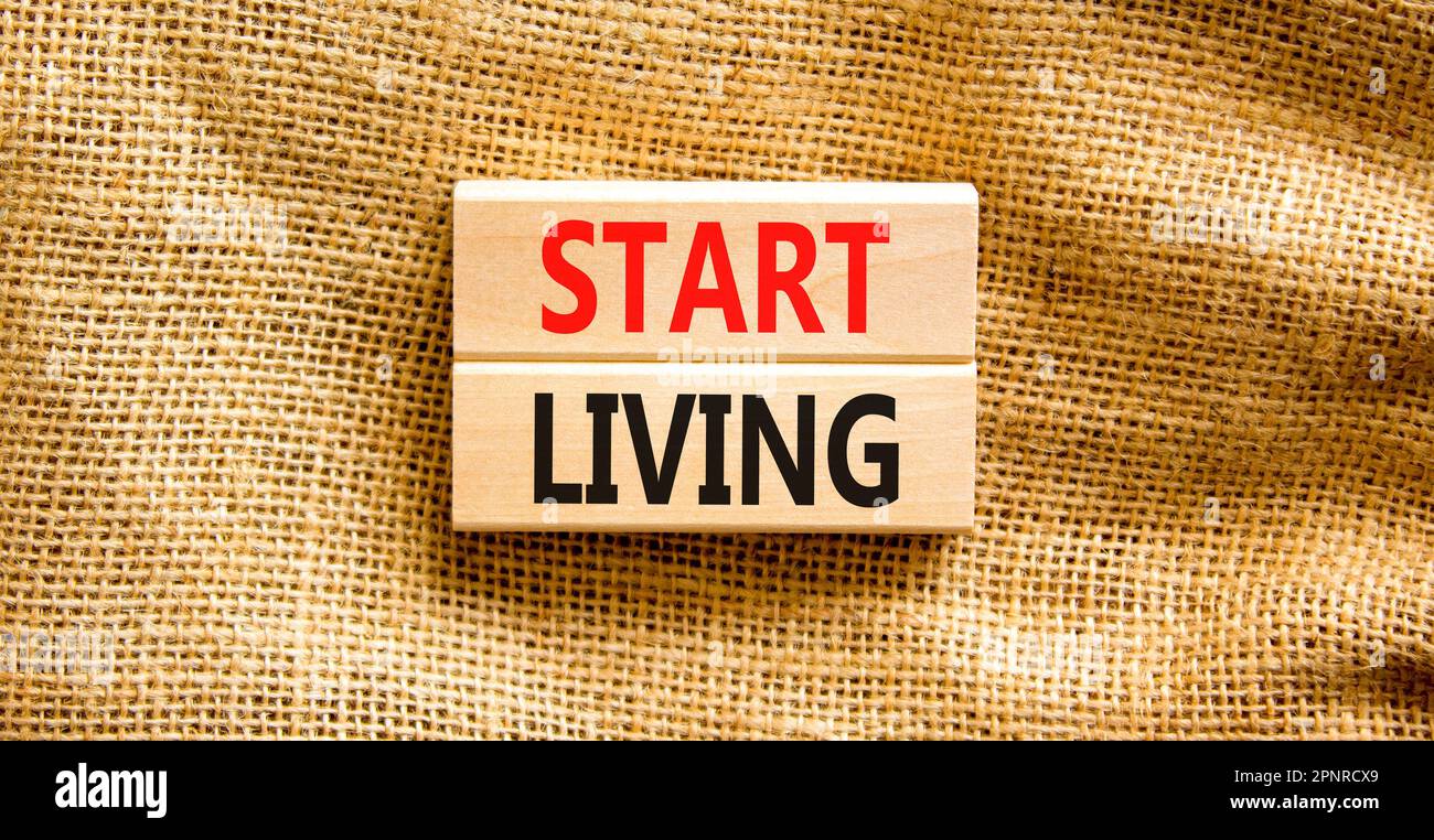 Start living symbol. Concept words Start living on beautiful wooden ...