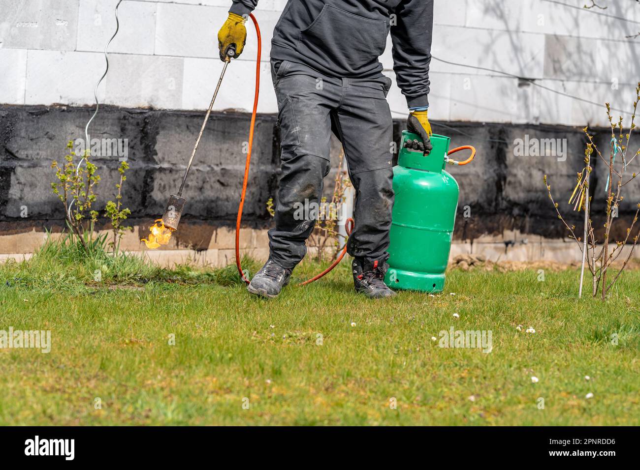 craftsman with a gas tank for a fire on a construction site Stock Photo ...