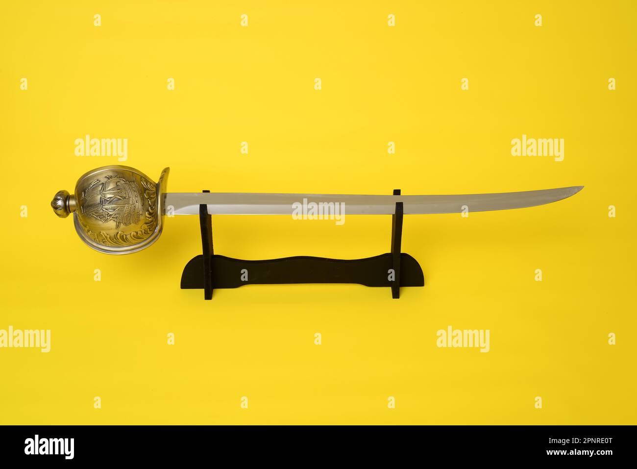 Cutlass on stand blade, guard, and hilt isolated over yellow Stock ...
