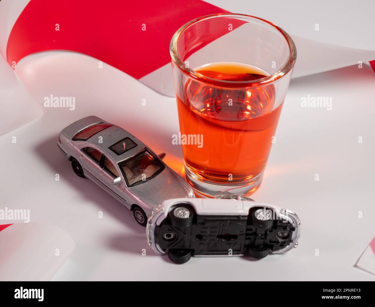 Mini car accident. Alcohol and a toy car on a light background. Drunk ...