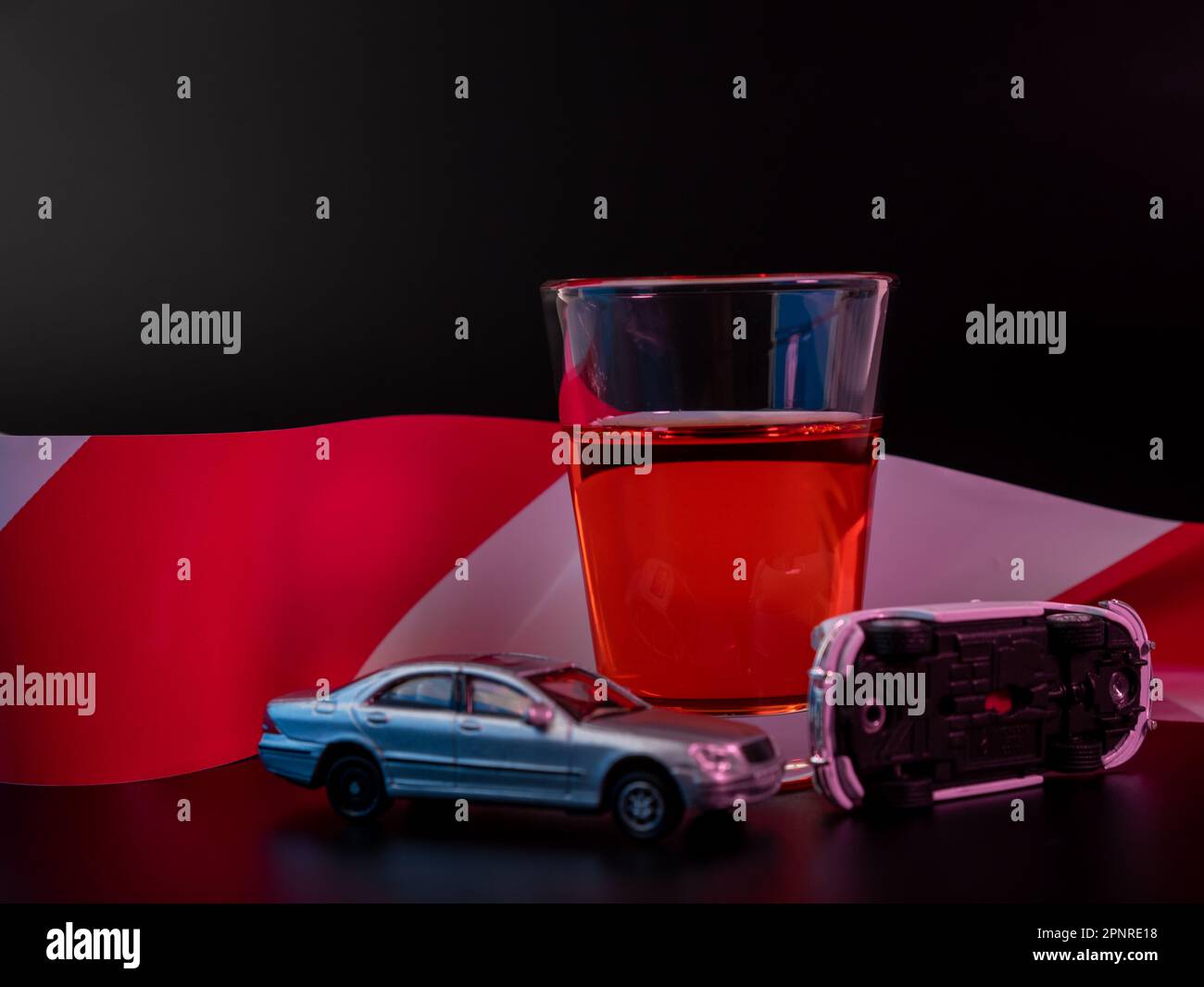 Mini car accident. Alcohol and a toy car on a black background. Drunk ...
