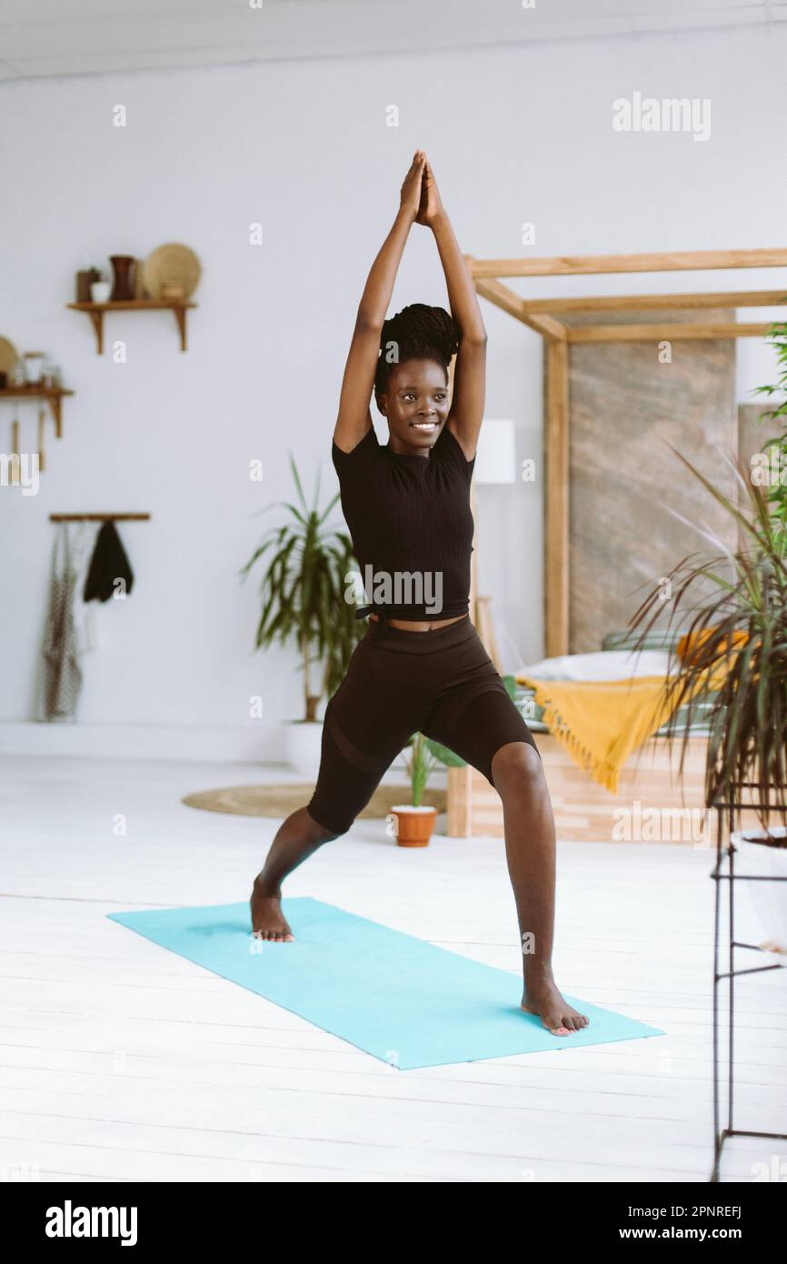 Vertical smiling, laughing dark skin multicultural woman practice yoga ...