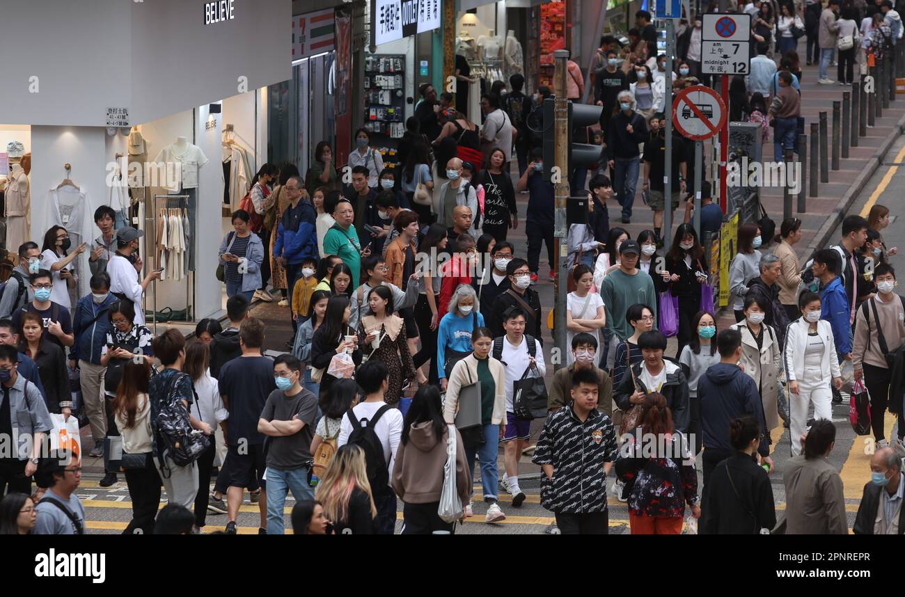 Shoppers walk along a street in Mong Kok during the Easter holidays ...