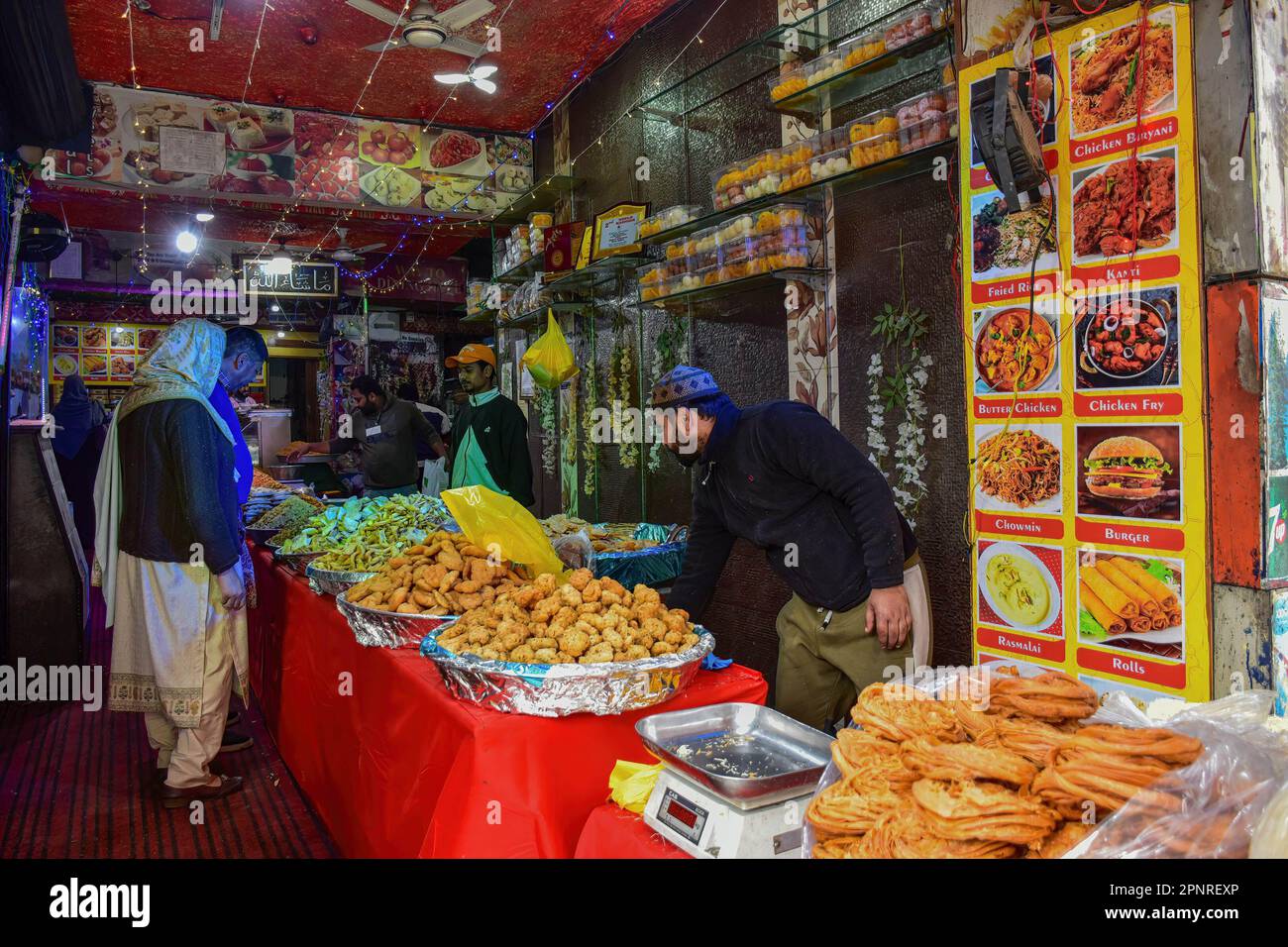 Kashmiri Muslims shop at a bakery store ahead of the Muslim festival ...