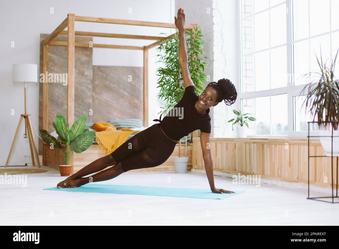 Laughing, smiling multicultural woman do yoga exercises on mat ...